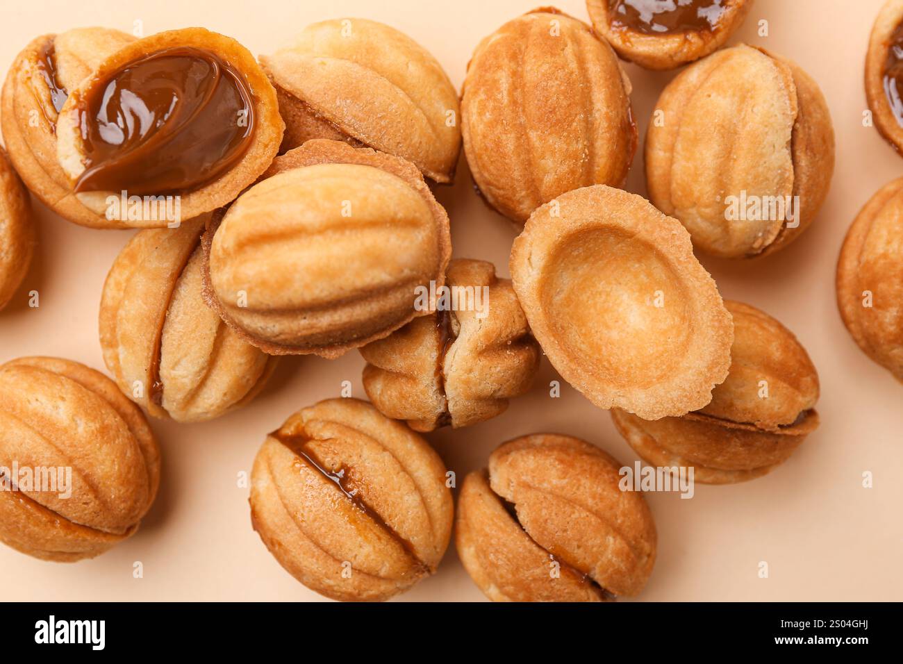 Sweet walnut shaped cookies with boiled condensed milk on beige ...
