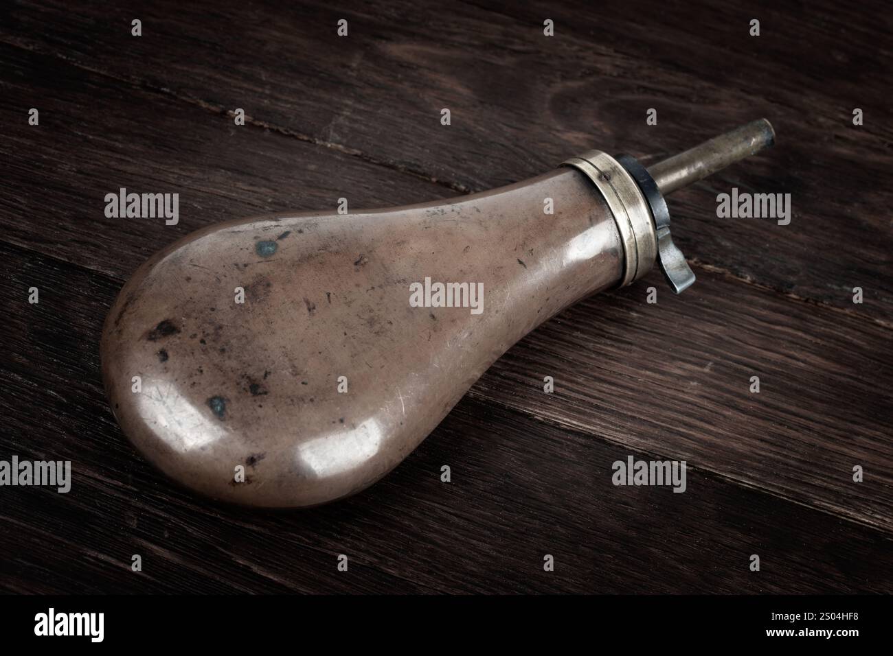 Old west gunpowder flask on wood deck background Stock Photo - Alamy