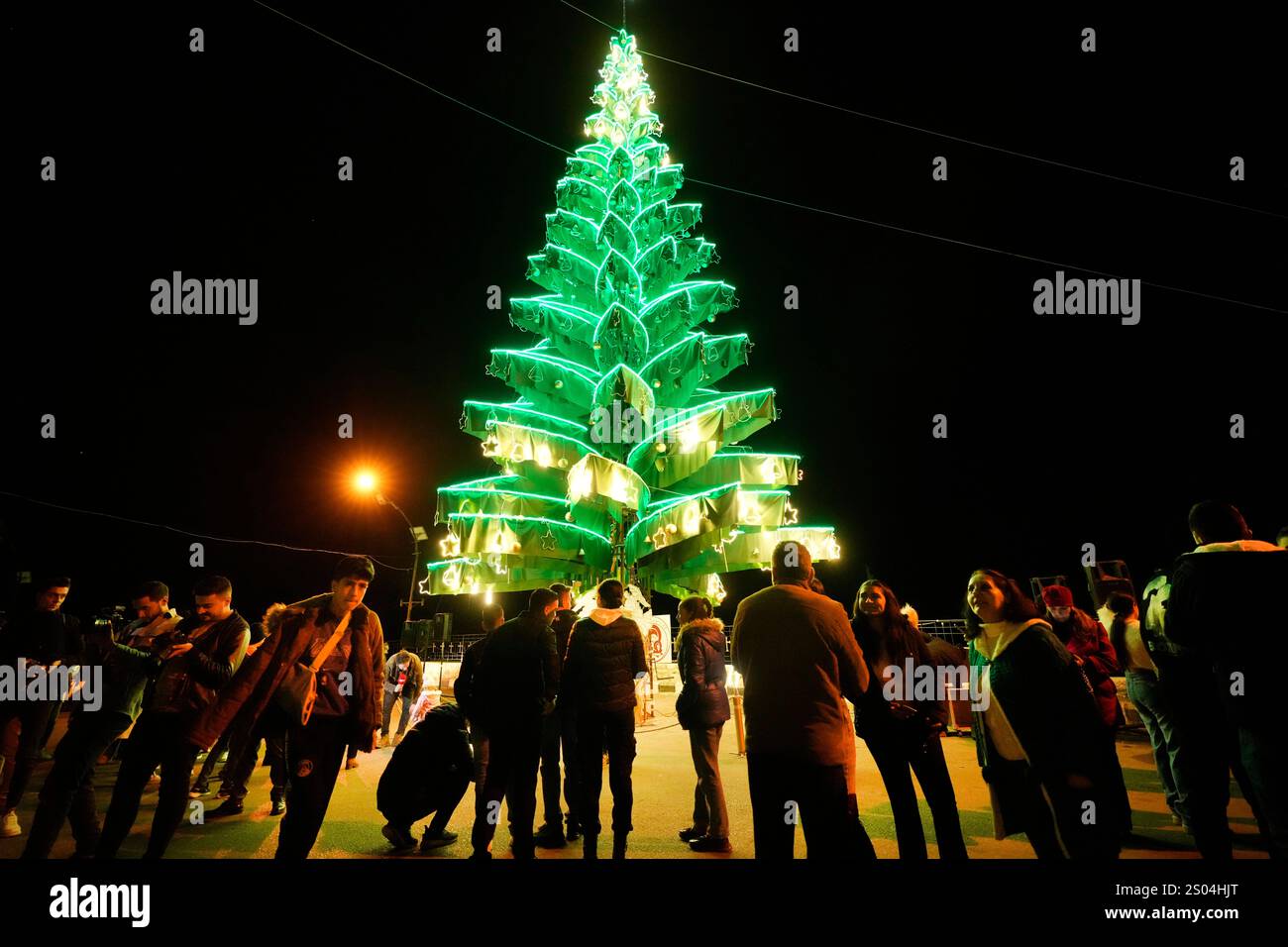 Syrian citizens gather outside Saydnaya Convent during the lighting of ...
