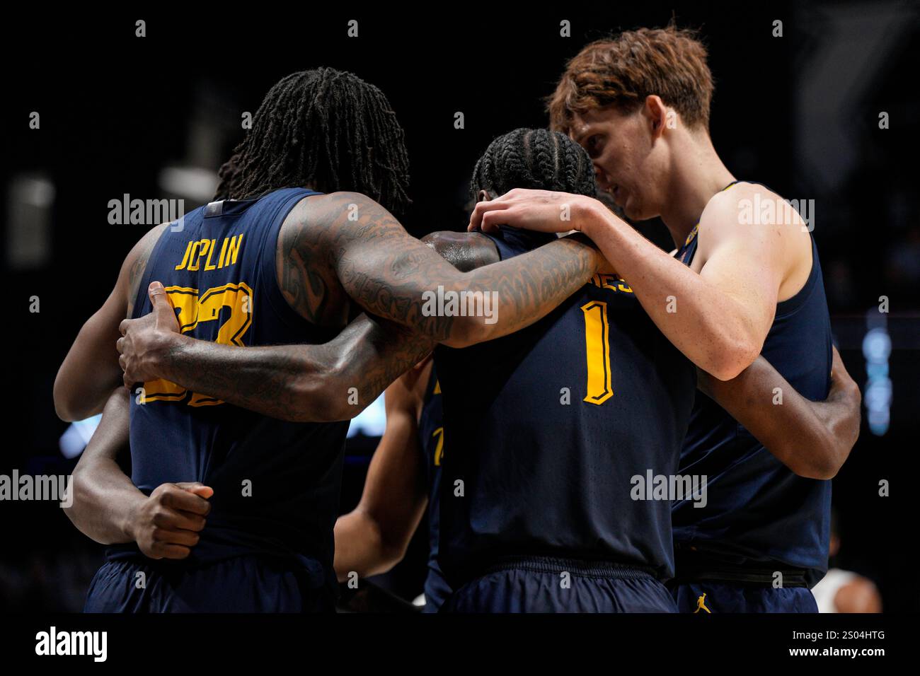 Marquette players huddle during an NCAA college basketball game against ...