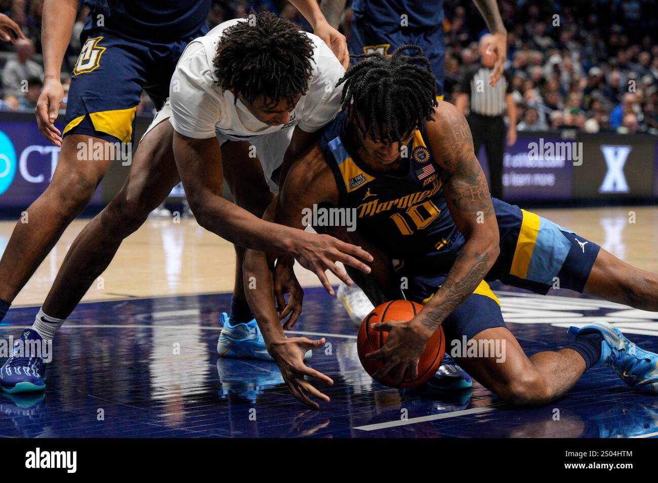Marquette forward Damarius Owens (10) battles for a loose ball with ...