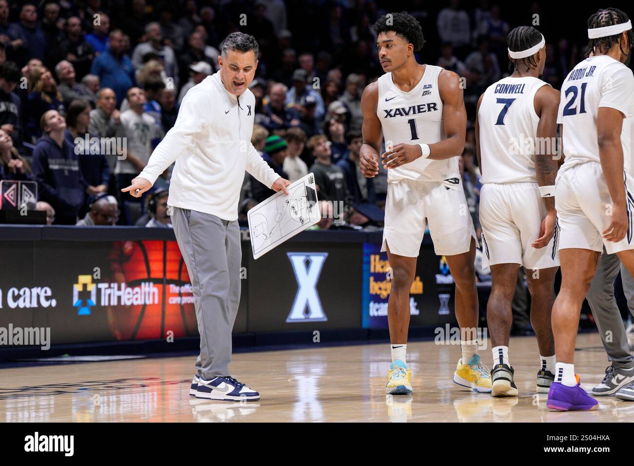 Xavier head coach Sean Miller, left, speaks with Marcus Foster (1 ...
