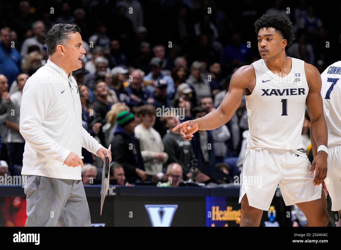 Xavier head coach Sean Miller, left, speaks with Marcus Foster (1 ...