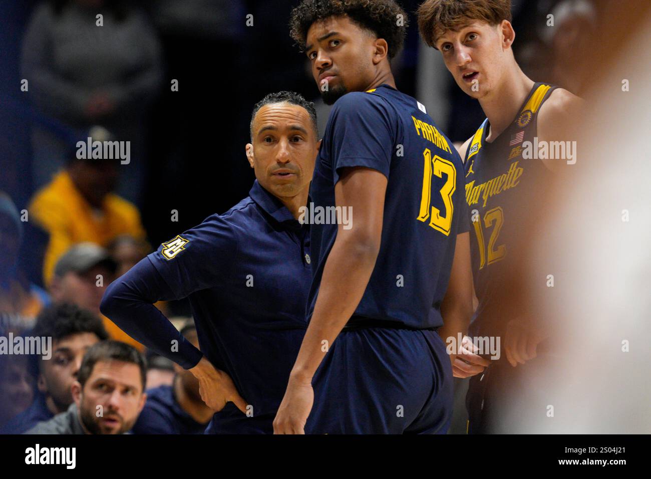 Marquette head coach Shaka Smart, center, speaks with Royce Parham (13 ...