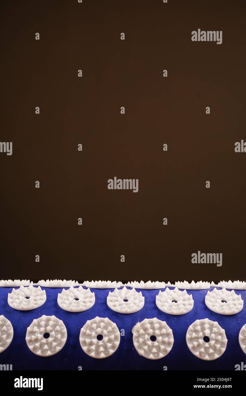 The blue acupressure mat features a textured design for massage. This ...