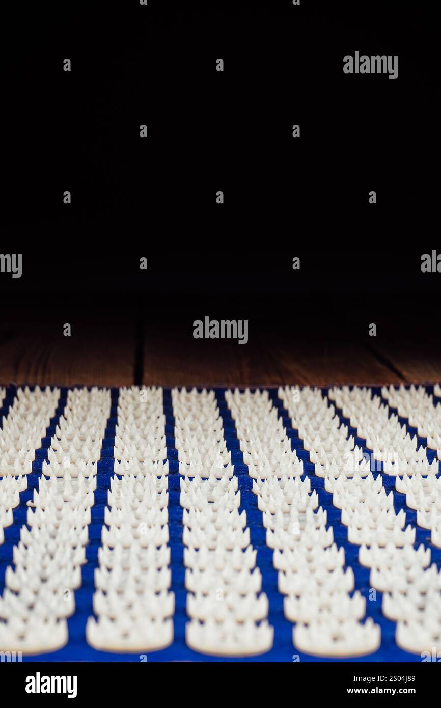 Close-up of a blue acupuncture mat designed for massage and relaxation ...
