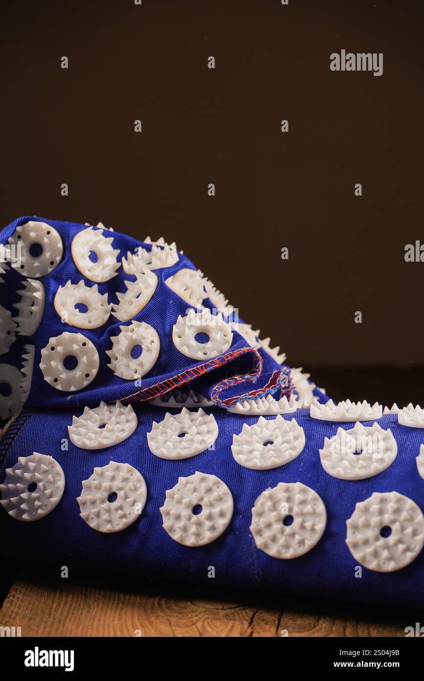 The blue acupressure mat features a textured design for massage. This ...