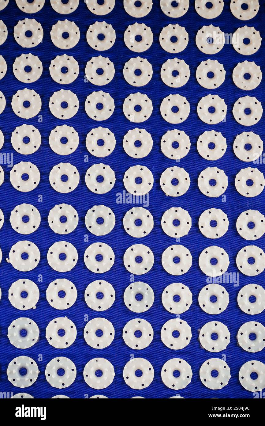 Close-up of a blue acupuncture mat designed for massage and relaxation ...