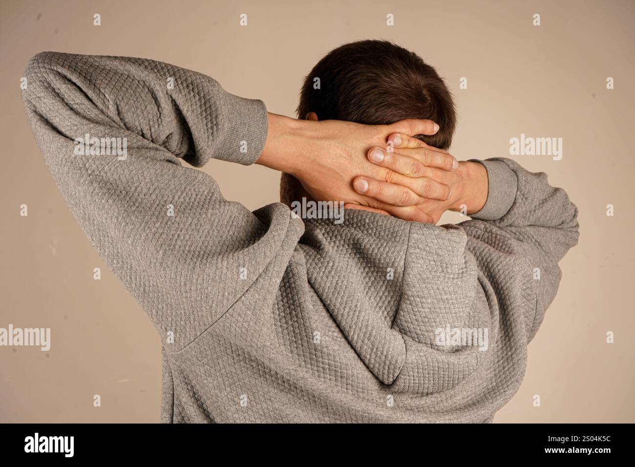Mans hands clasped behind head hi-res stock photography and images - Alamy