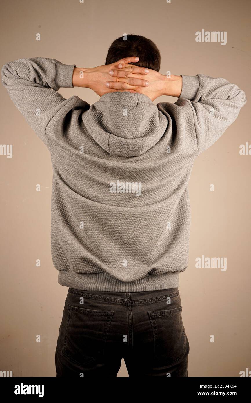 Hands clasped together. Hands on back of man's head. Relaxed and ...