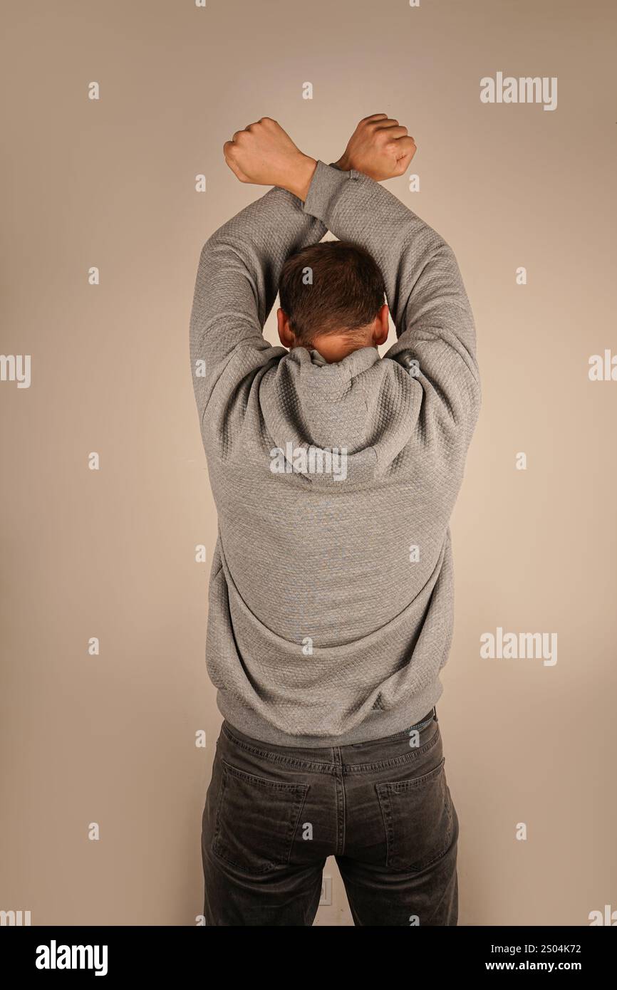 With arms crossed and palms in fists, the man adopts a strong ...