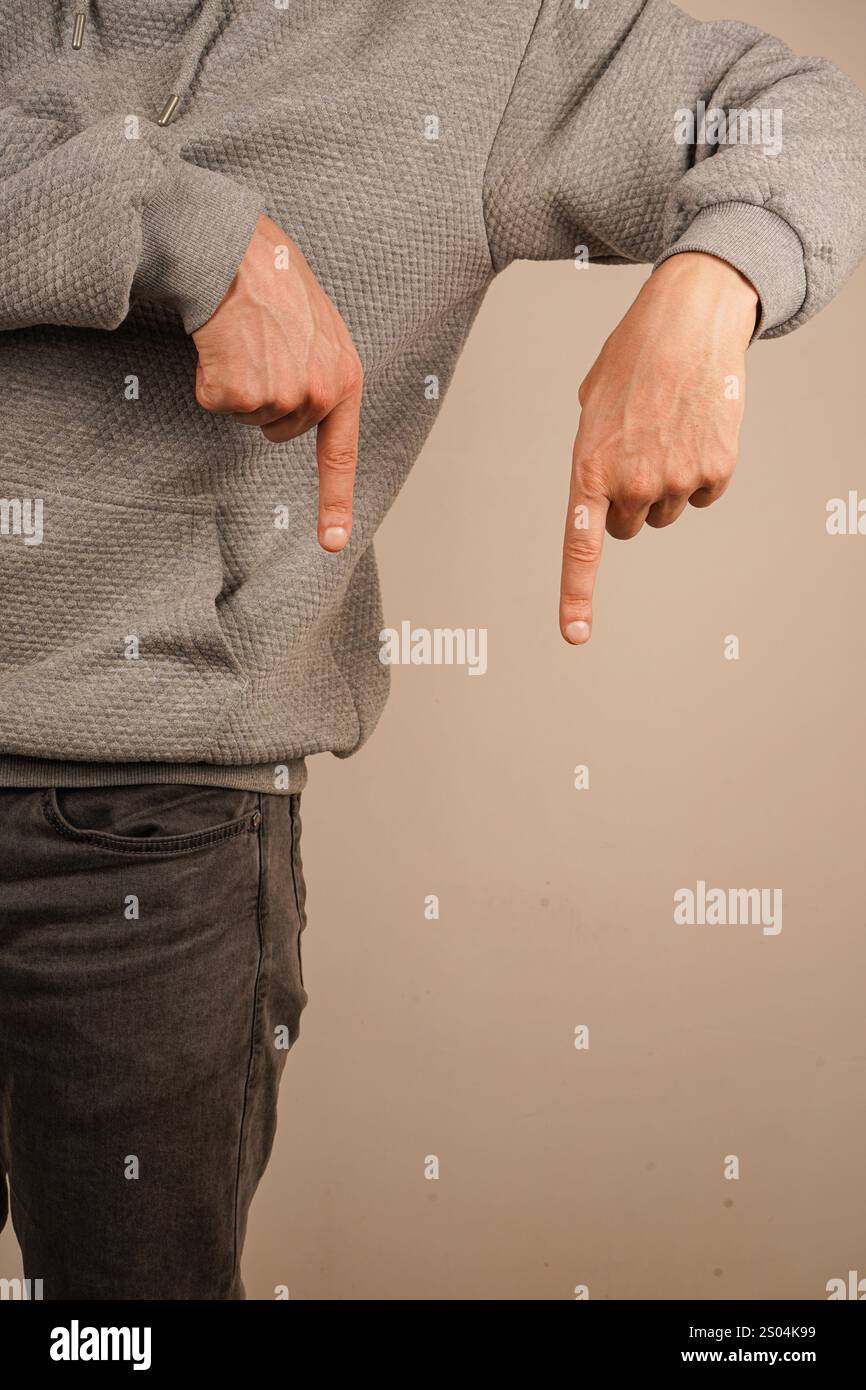 The plain light wall enhances the minimalist aesthetic. Hands showing a ...