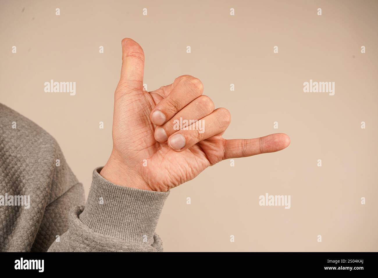 A hand shows a gesture with three fingers pressed against the palm ...