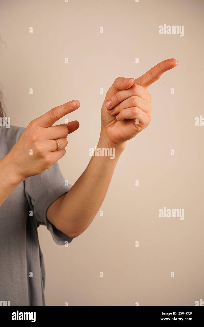The focus is on the natural texture of the gray sweater. Hands showing ...