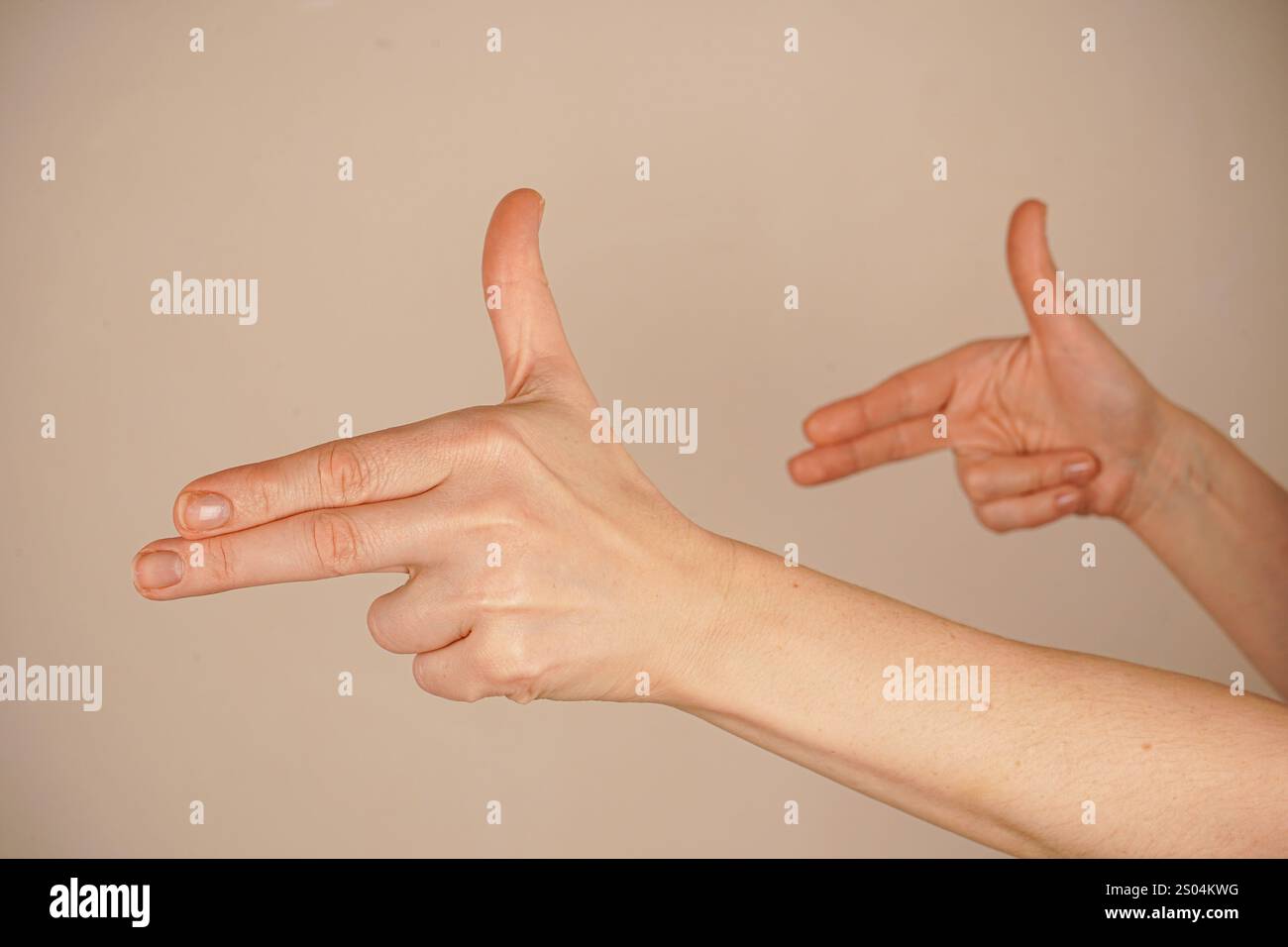 Two hands show a gun game. The gesture conveys a playful or symbolic ...