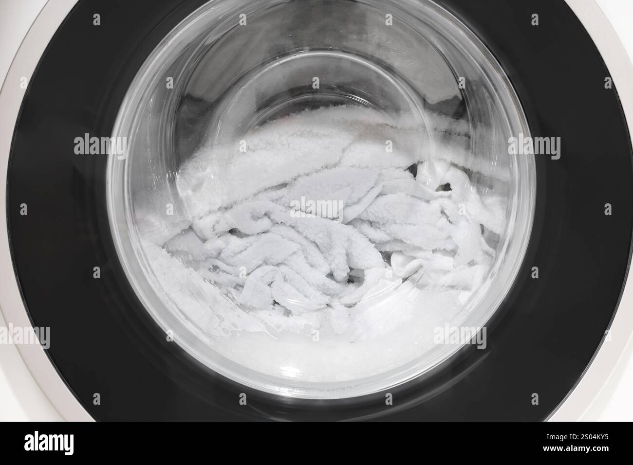 Washing machine with clothes as background, closeup Stock Photo - Alamy