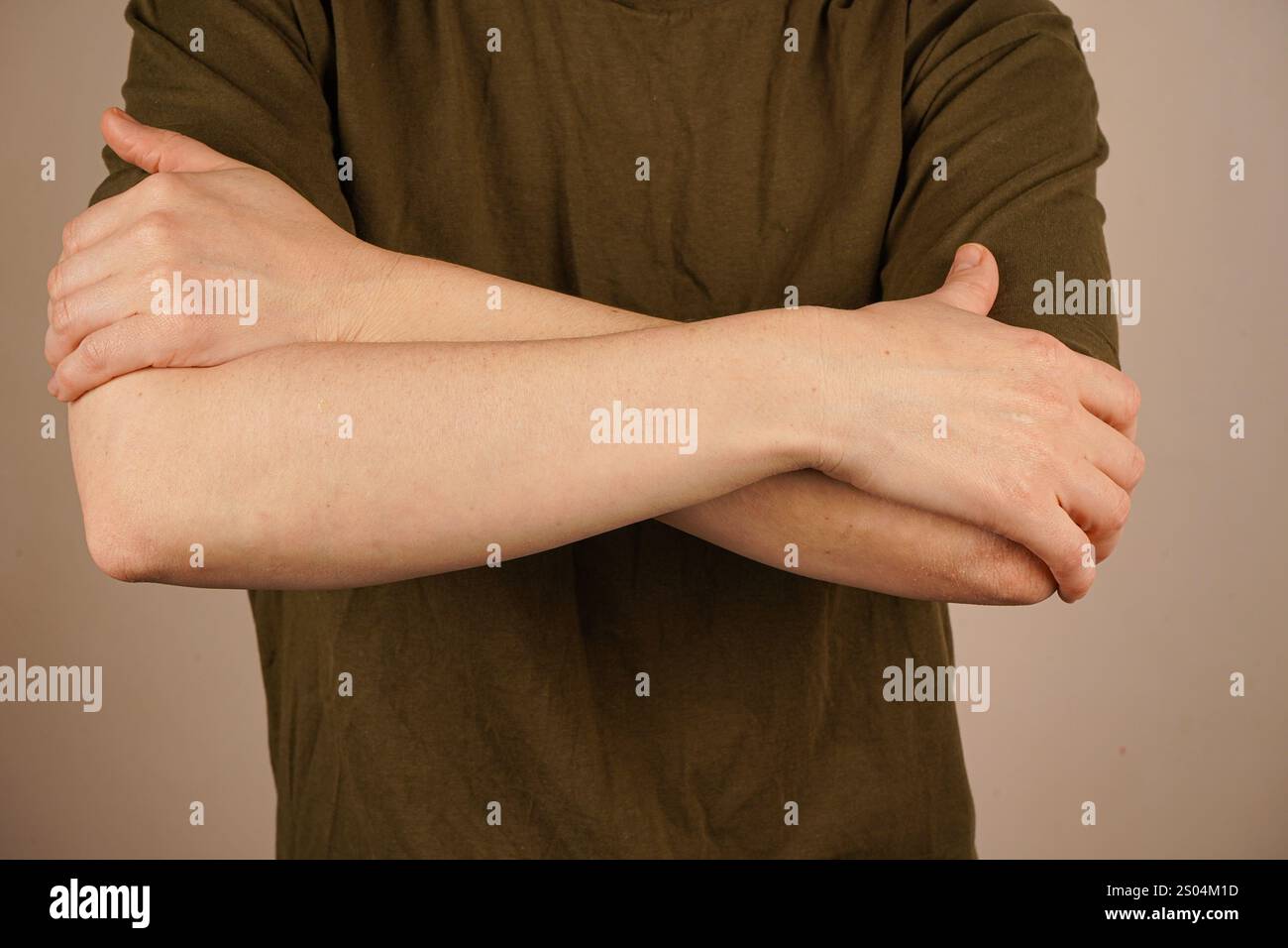 Clasped hands form a symbolic gesture of unity against a light, neutral ...