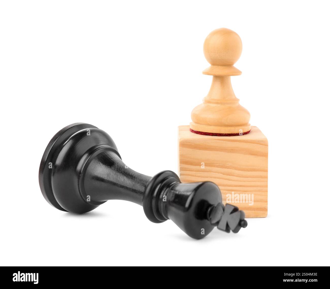 Pawn on wooden block near fallen king chess against white background ...