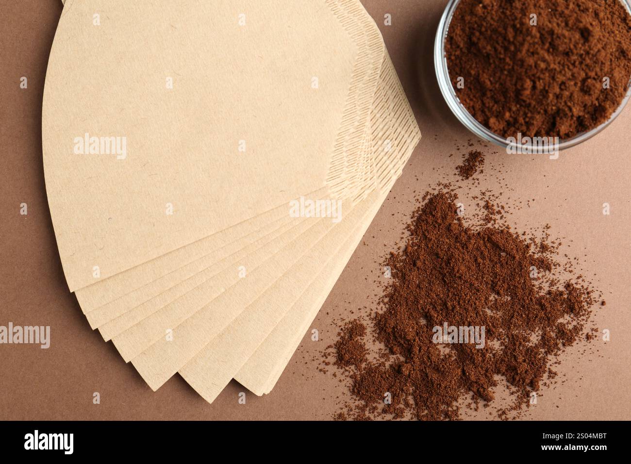 Paper filters and instant coffee on brown background, flat lay Stock ...