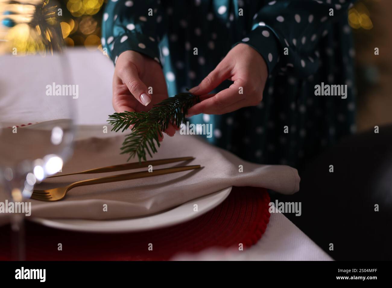 Woman setting table for Christmas dinner at home, closeup Stock Photo ...