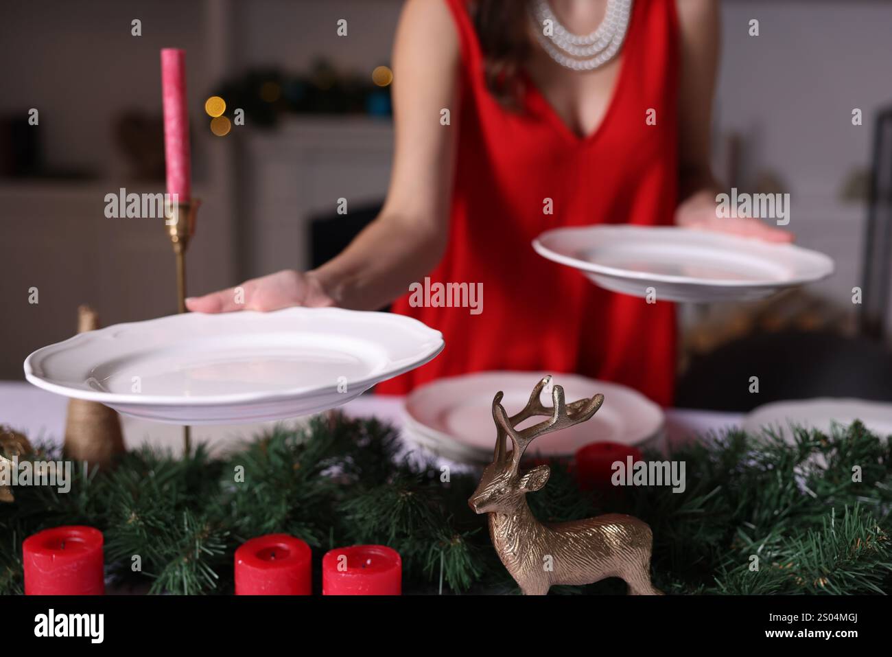 Woman setting table for Christmas dinner at home, closeup Stock Photo ...