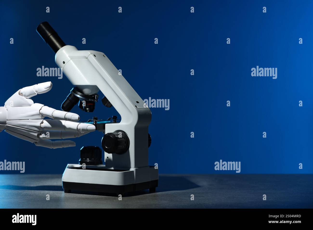 Artificial intelligence. Robot hand working with microscope at table ...