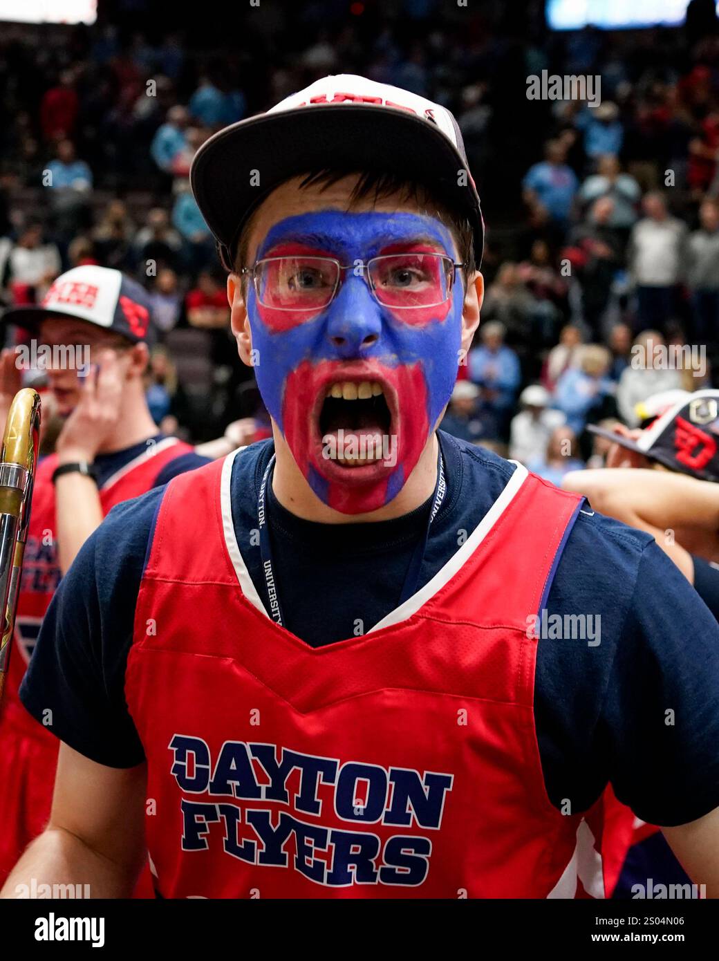 A member of the Dayton band cheers prior to the first half of an NCAA ...