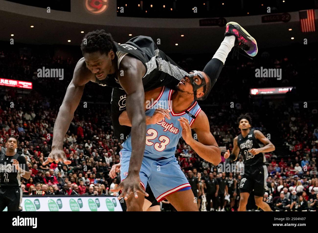 Cincinnati forward Aziz Bandaogo (55) leaps over Dayton forward Zed Key ...