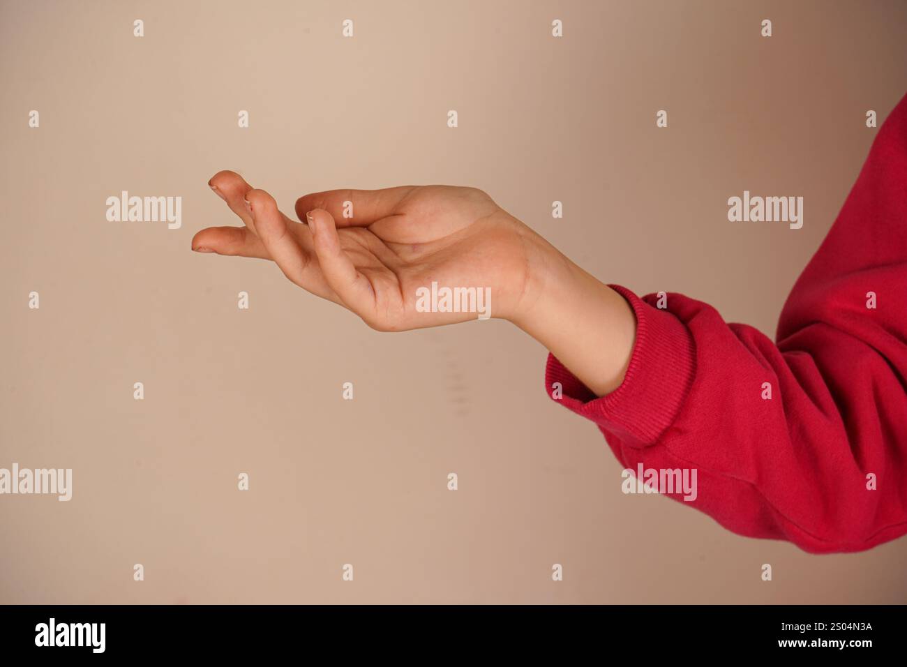 The hand is extended with the palm facing up. On a light background of ...