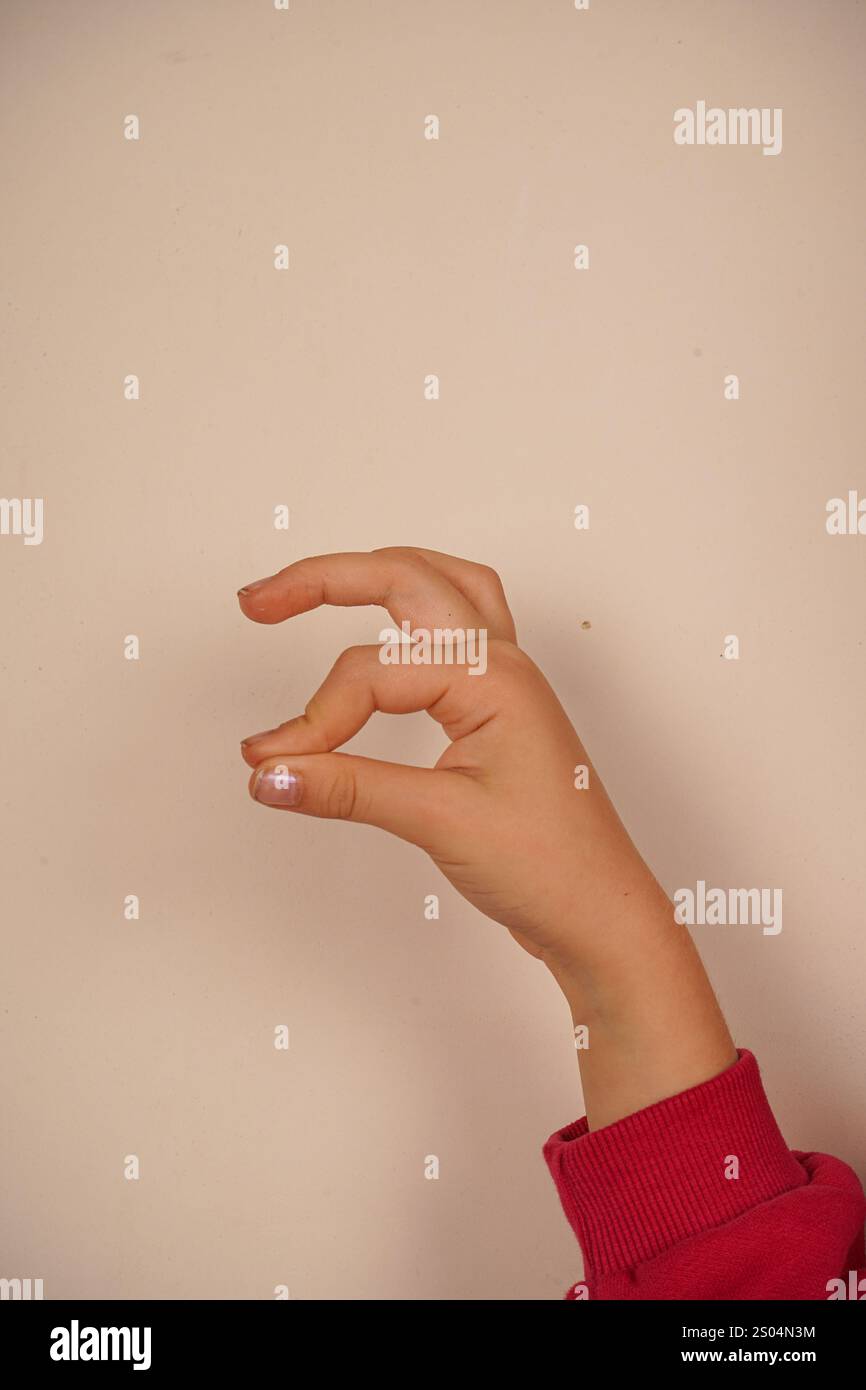 A clean, minimalist background enhances focus on the gesture. A human ...