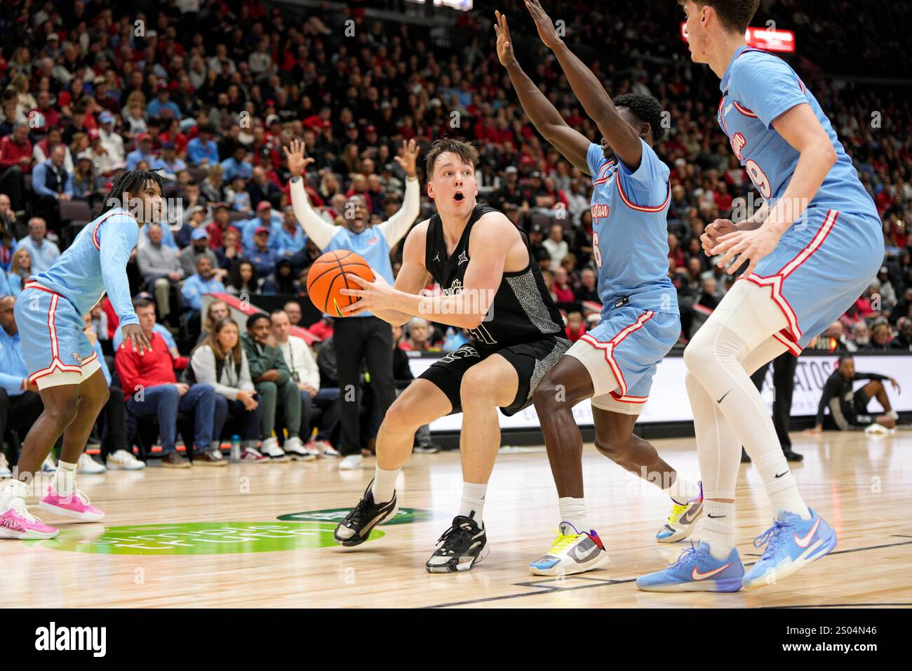 Cincinnati guard Simas Lukosius (41) dribbles against Dayton guard ...