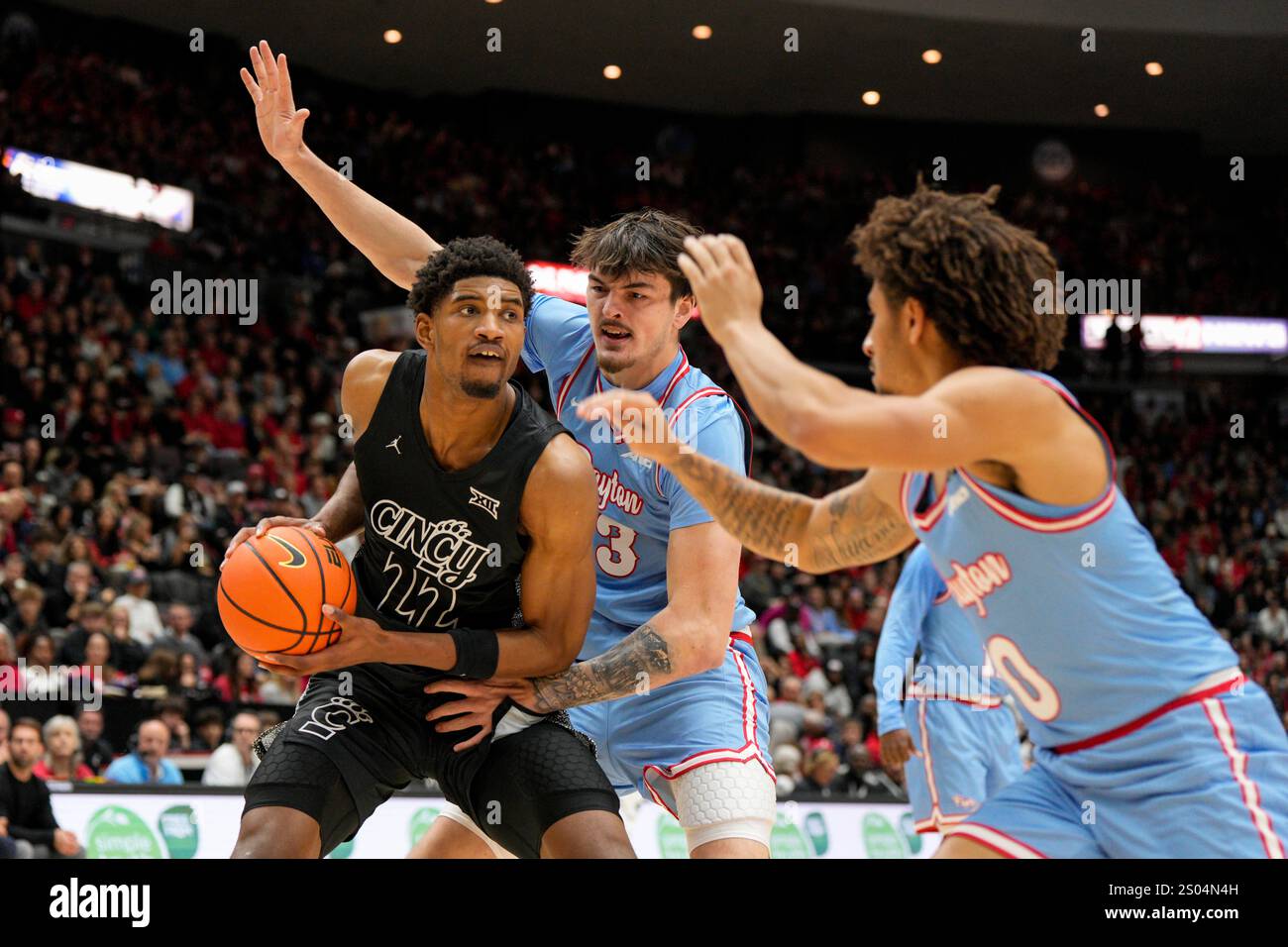 Cincinnati forward Arrinten Page (22) controls the ball against Dayton ...