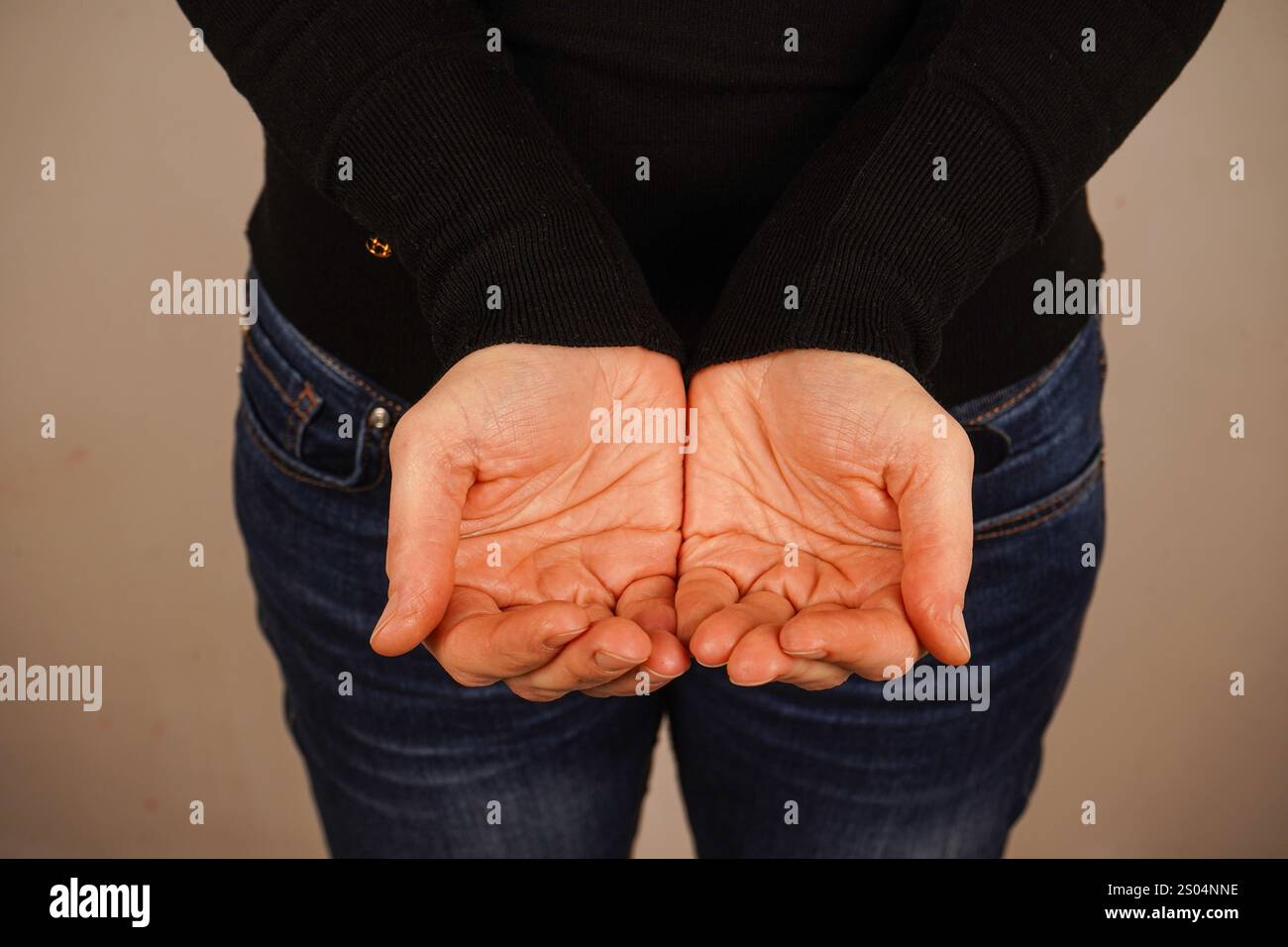 Two hands lie side by side, forming a symbol of peace and kindness. The ...