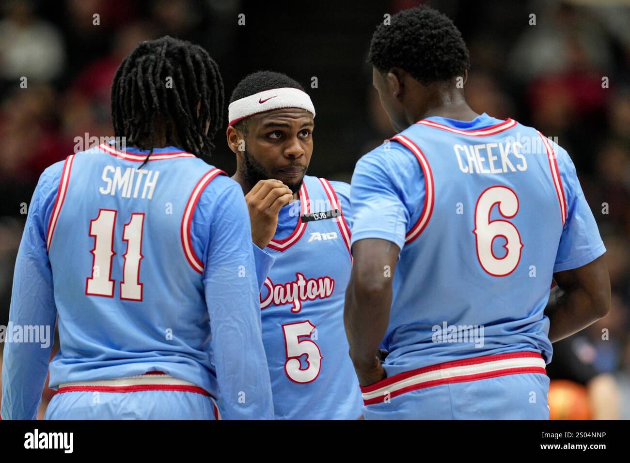 Dayton's Posh Alexander (5) speaks with teammate Enoch Cheeks (6) and ...