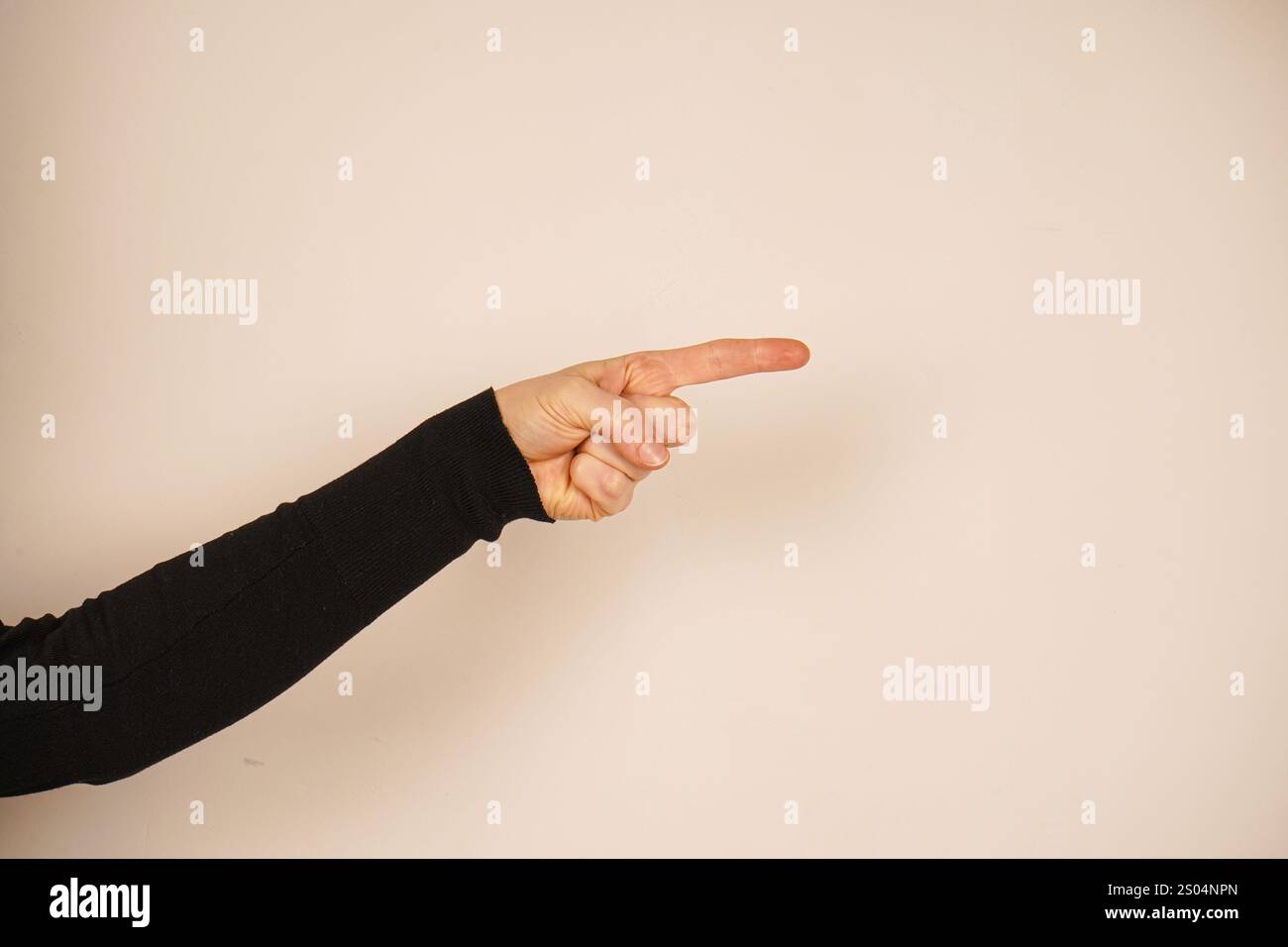 A hand with the index finger extended forward creates a gesture of ...