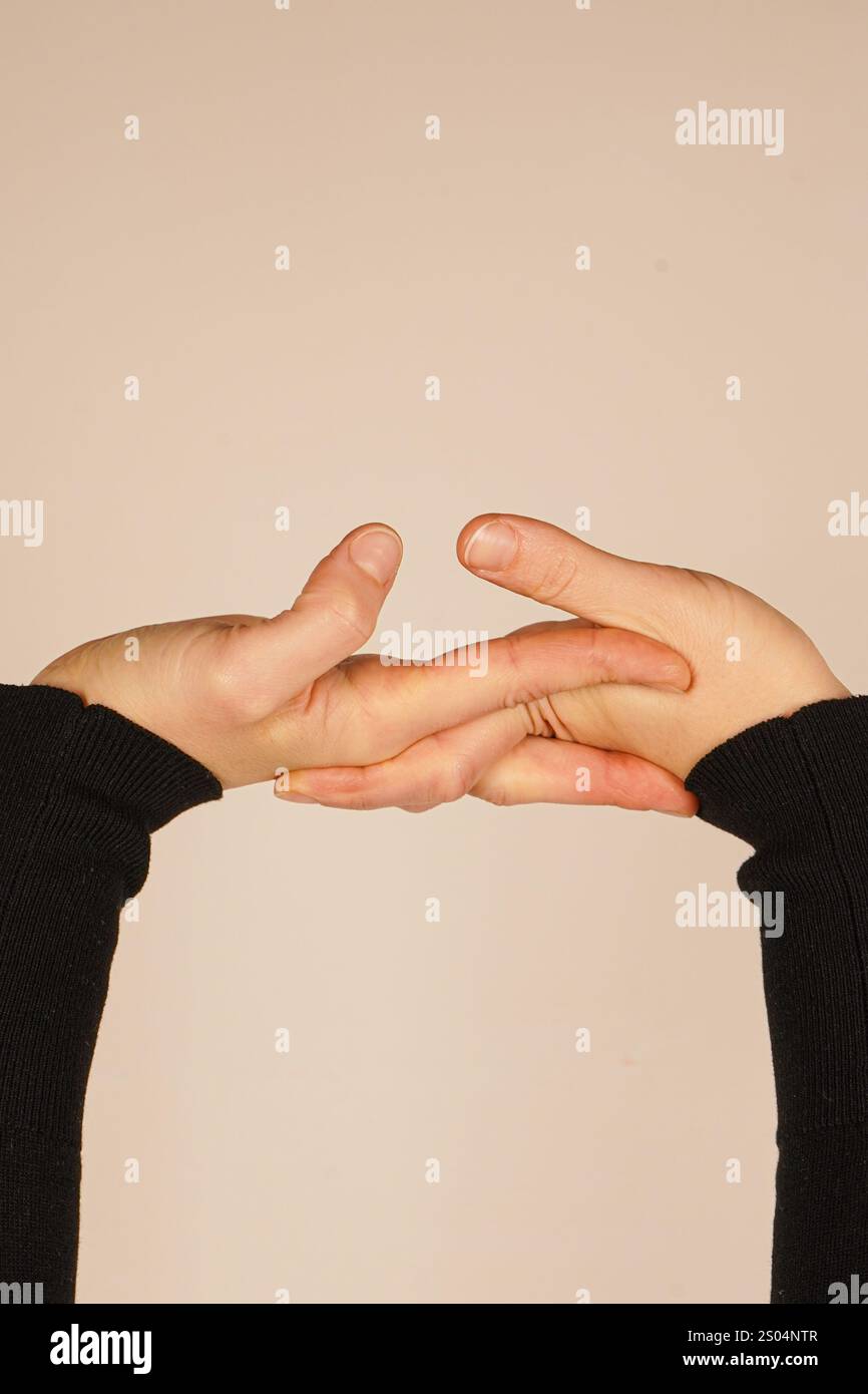 Two hands interlock their fingers to form a closed pose. This powerful ...