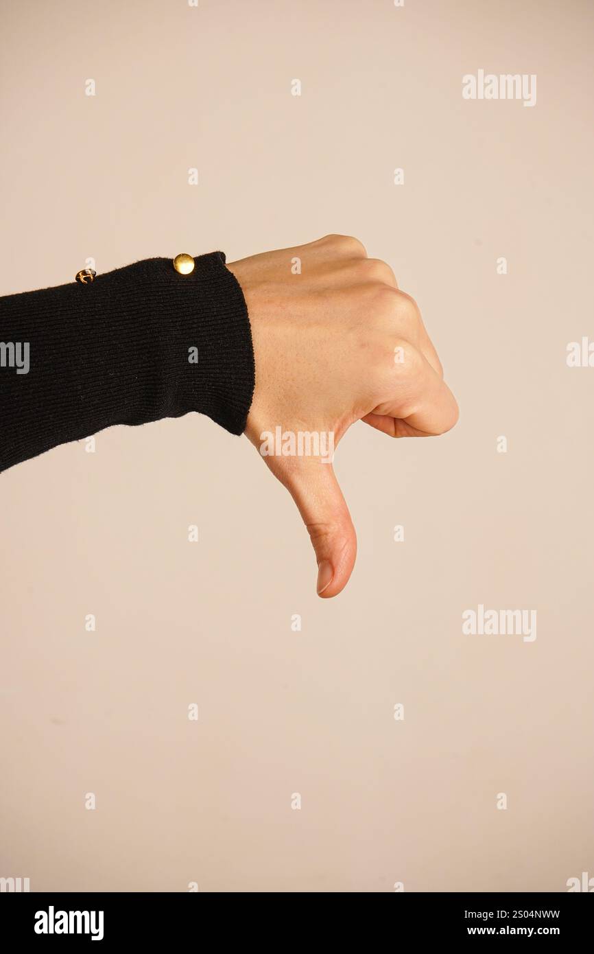 With the thumb pointed down, the hand conveys a strong sense of ...