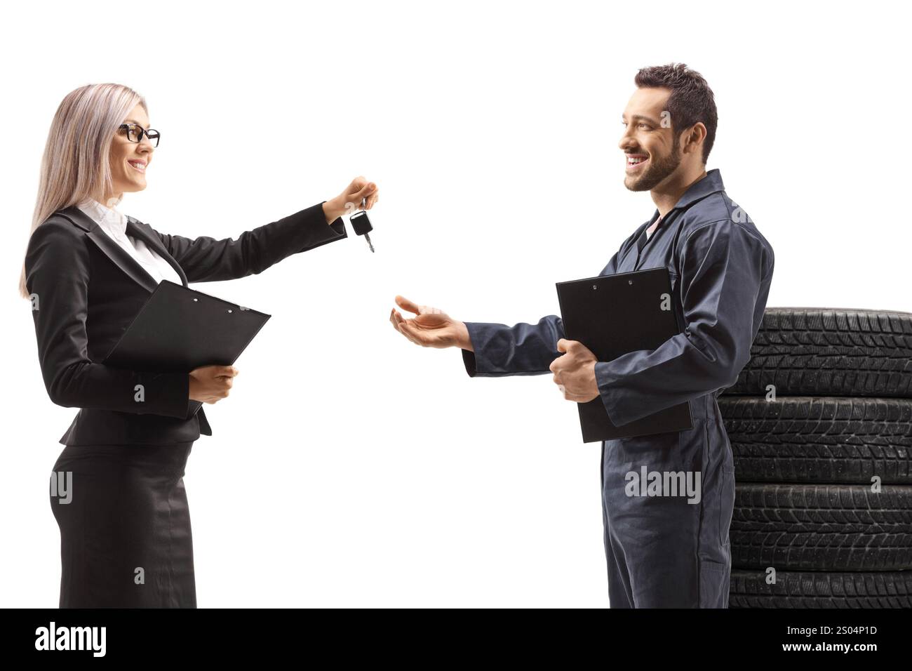 Businesswoman giving car keys to an auto mechanic standing next to a ...