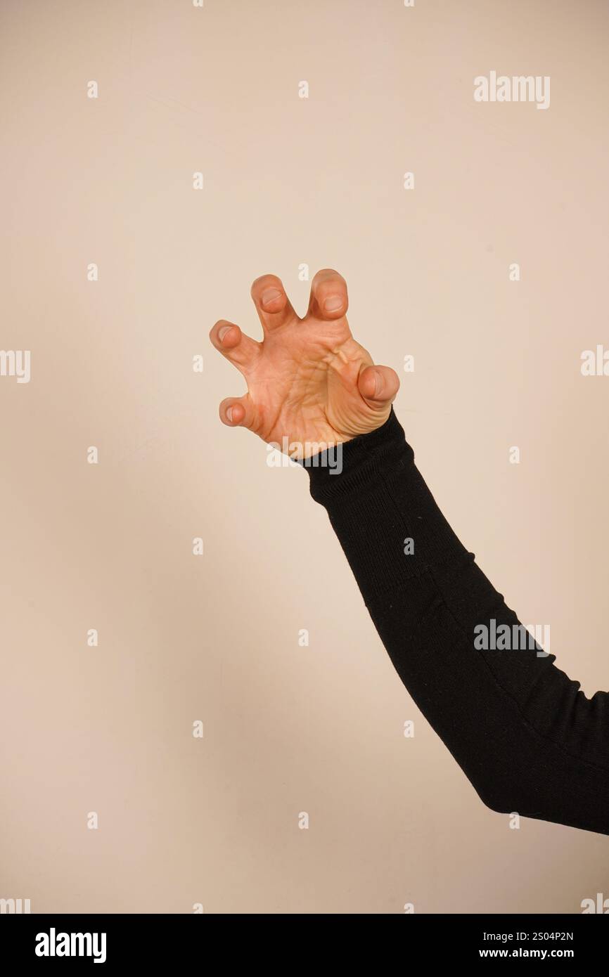 With fingers curved and spaced out, the hand replicates a cat's paw in ...