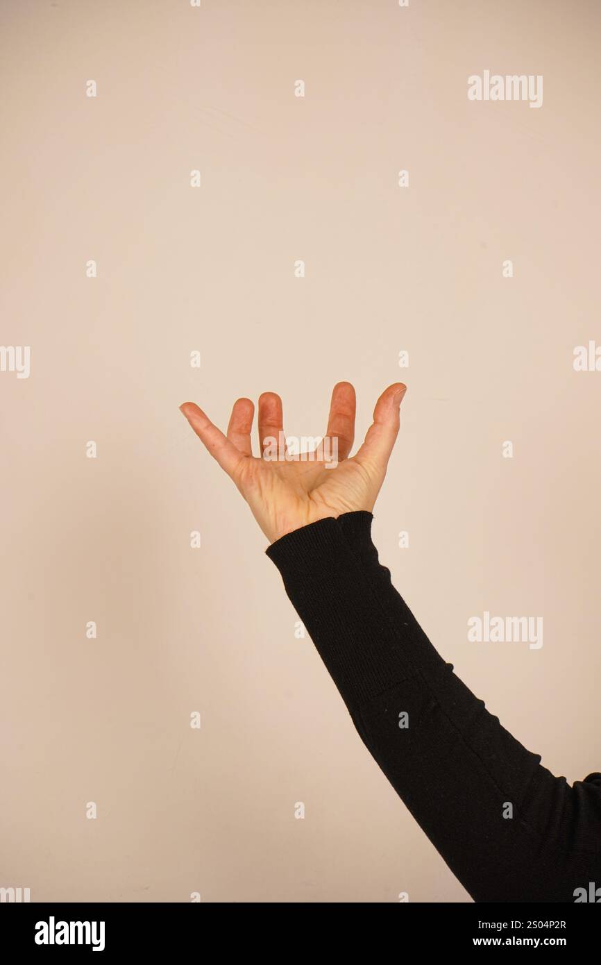 With fingers curved and spaced out, the hand replicates a cat's paw in ...