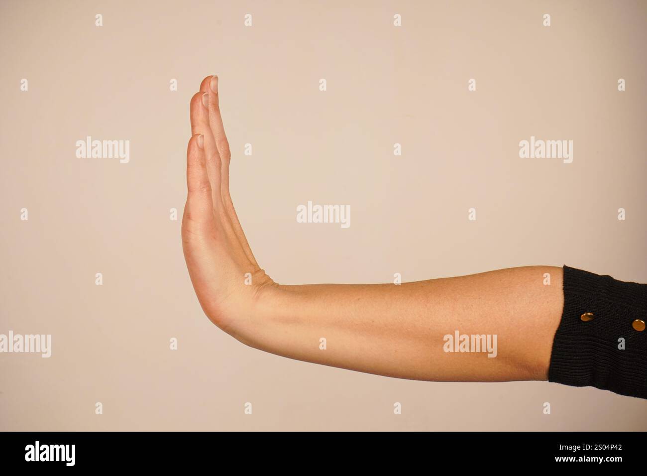 The open palm is raised forward, signaling the need to stop or slow ...