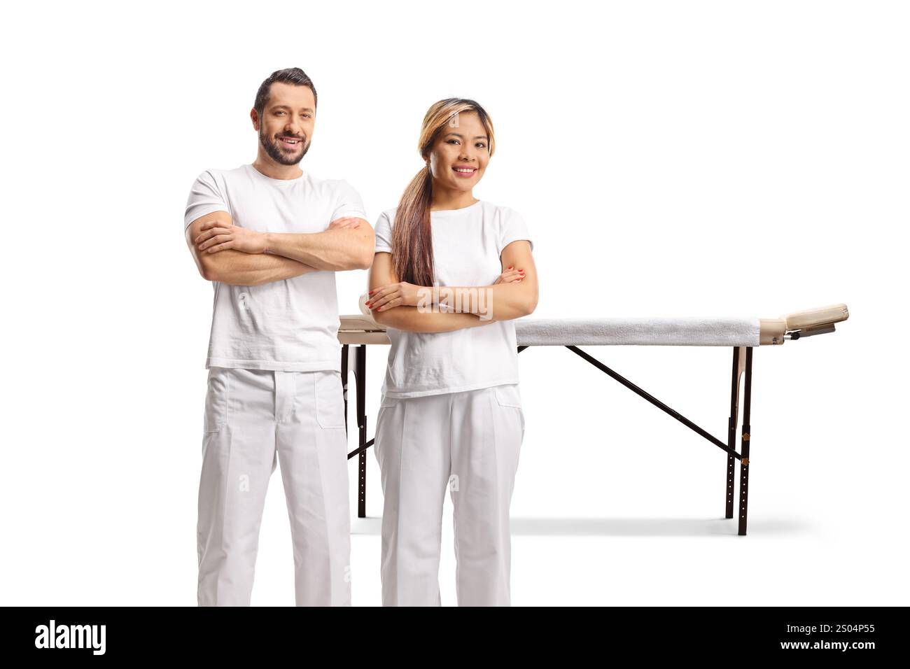 Male and female massage therapists in front of a massage table isolated ...