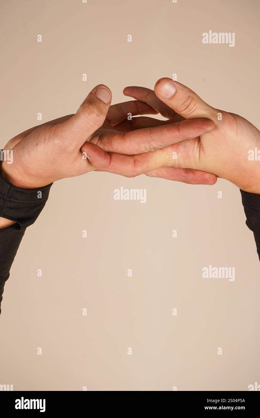 Two hands interlock their fingers to form a closed pose. This powerful ...