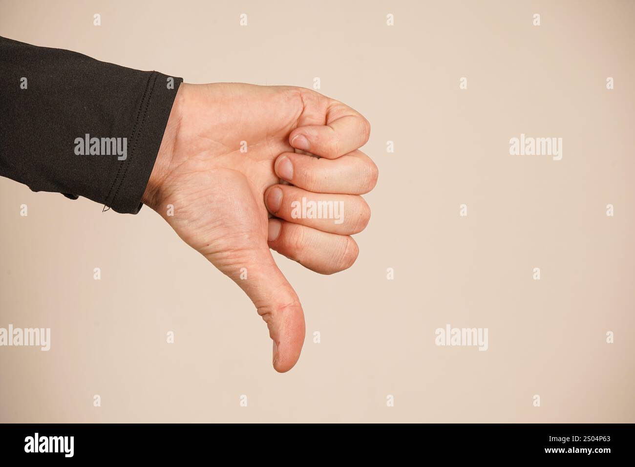 A hand showing a thumbs down, signaling disapproval or rejection. This ...