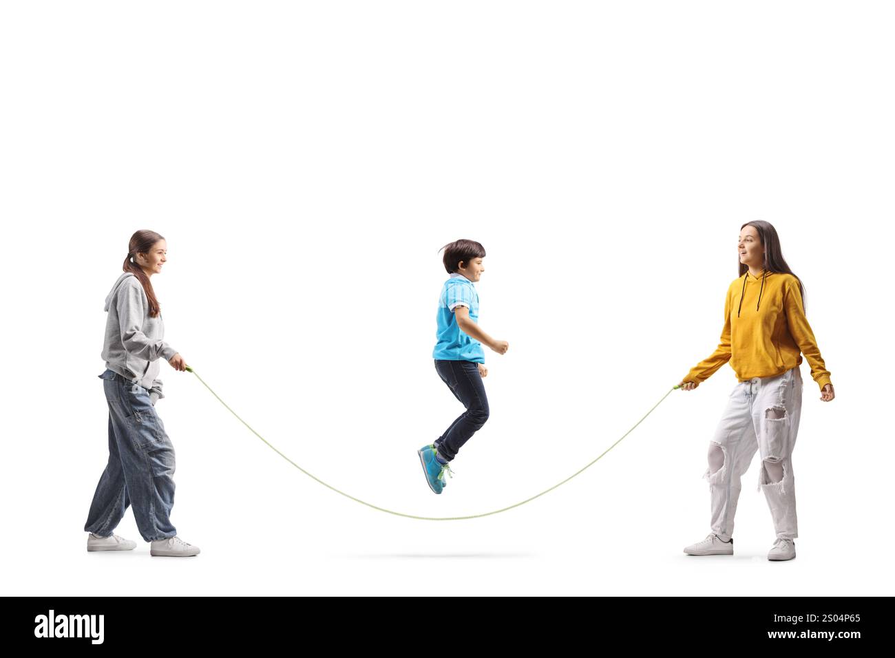 Boy playing skipping rope with teenage girls isolated on white ...