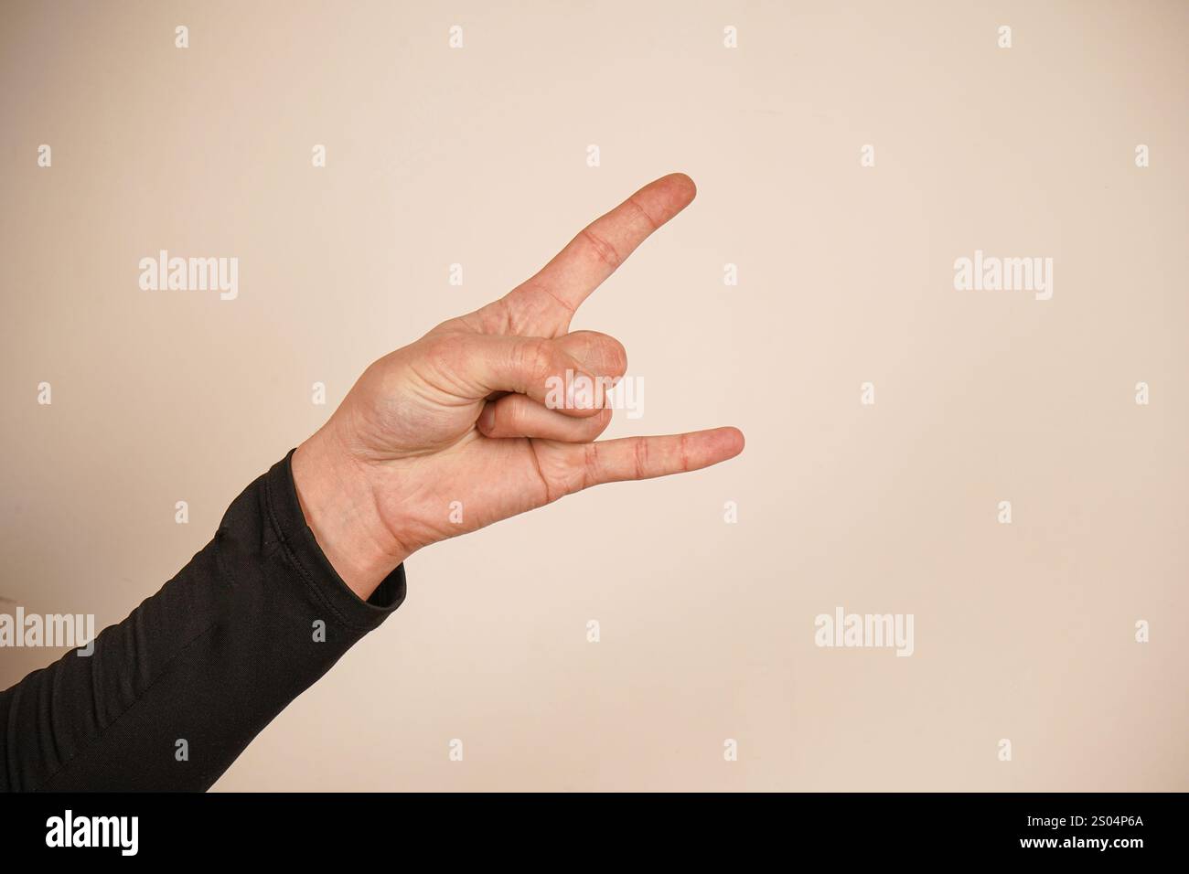 The hand raised in the classic rock and roll gesture symbolizes ...