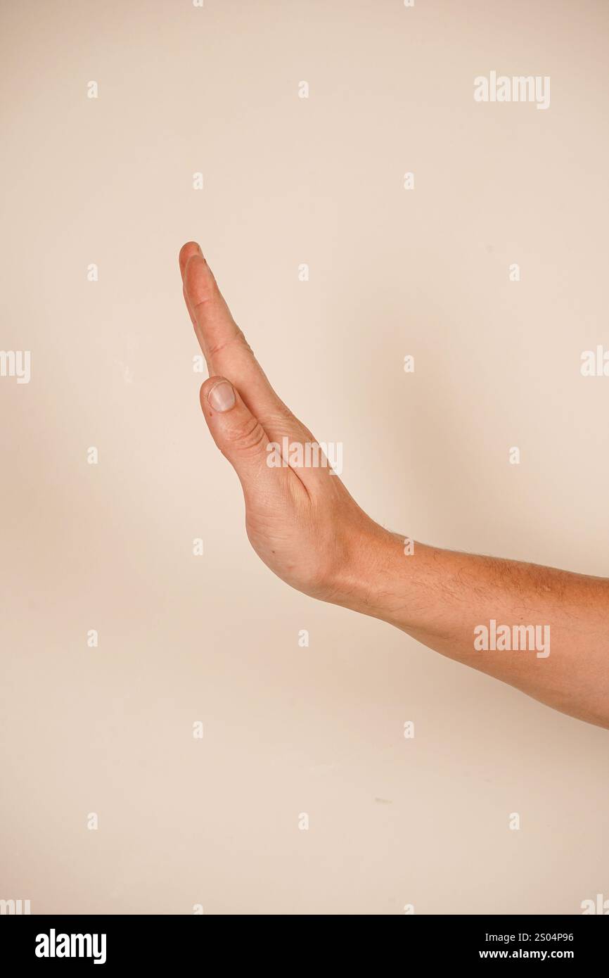 With the palm open and facing outward, the hand gestures a stop or ...