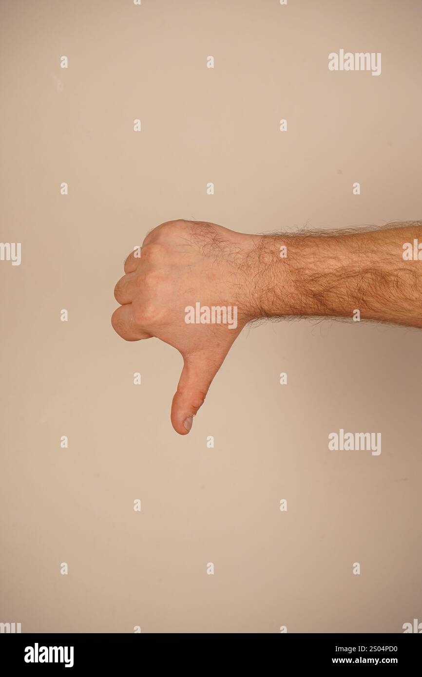 A hand showing a thumbs down, signaling disapproval or rejection. This ...