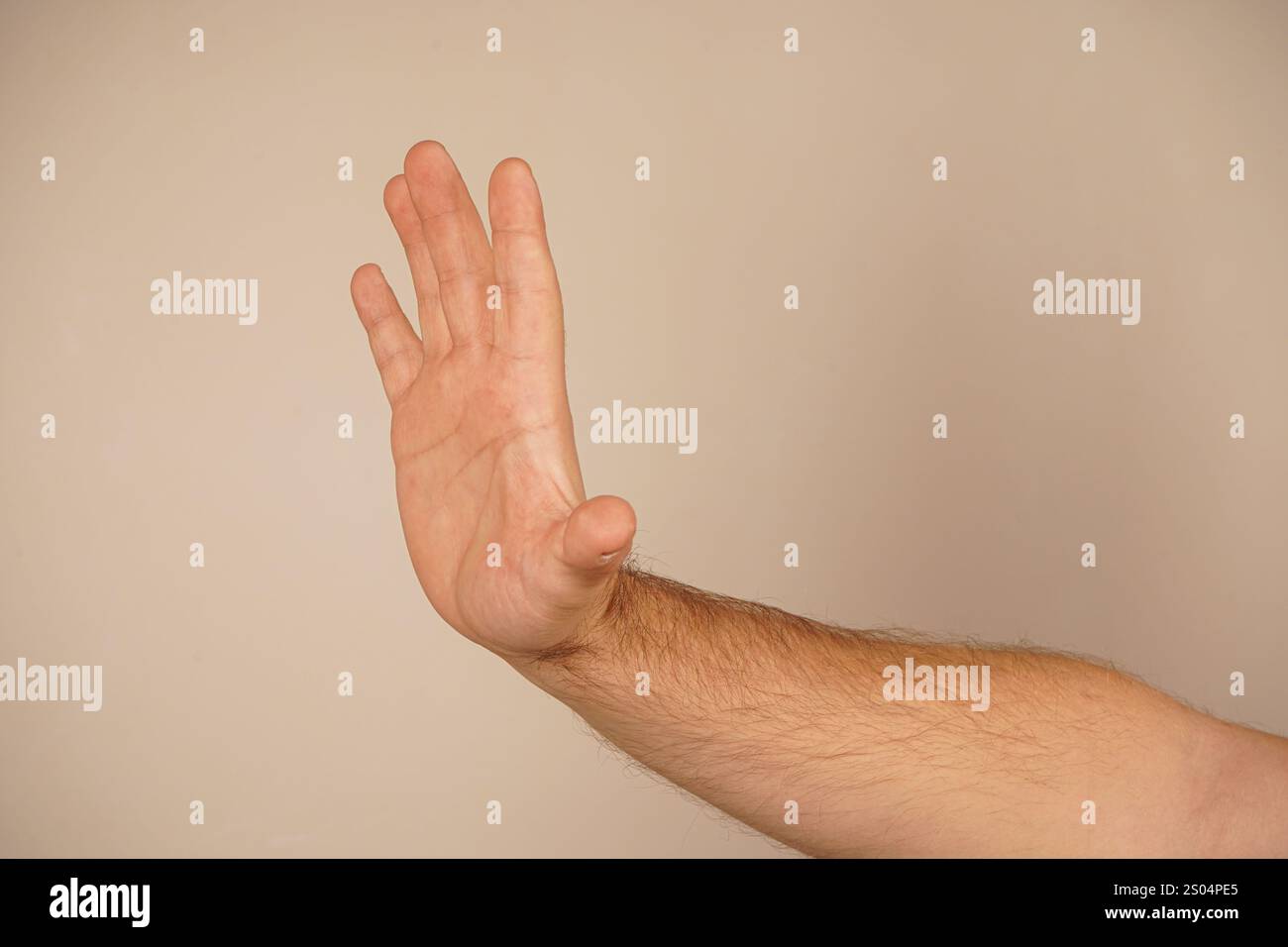 With the palm open and facing outward, the hand gestures a stop or ...