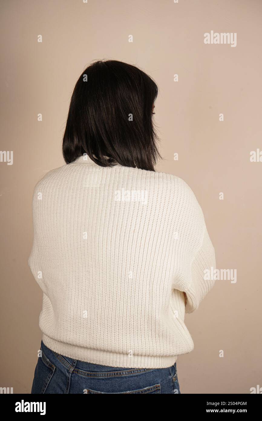 The black bob is neatly flowing when viewed from behind, showcasing its ...